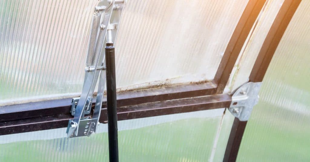 How to build a greenhouse from old windows - craftingwithconcrete.com