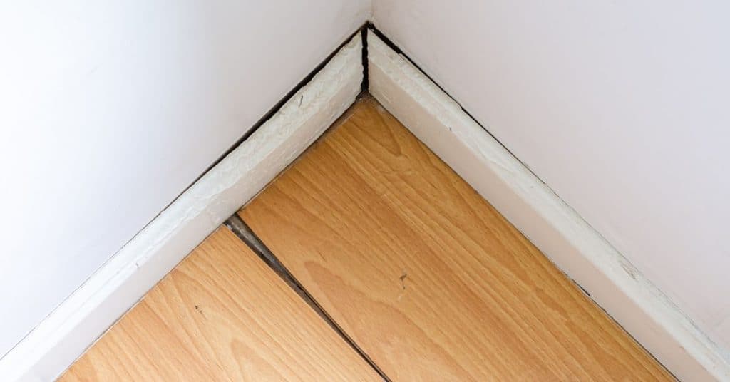 How to scribe baseboard to floor - craftingwithconcrete.com